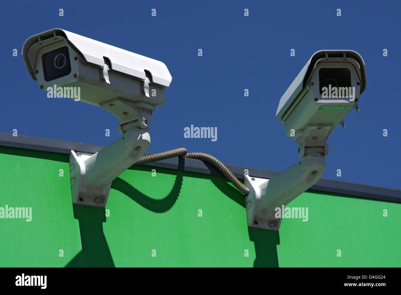 two security cameras on the roof facade Stock Photo - Alamy