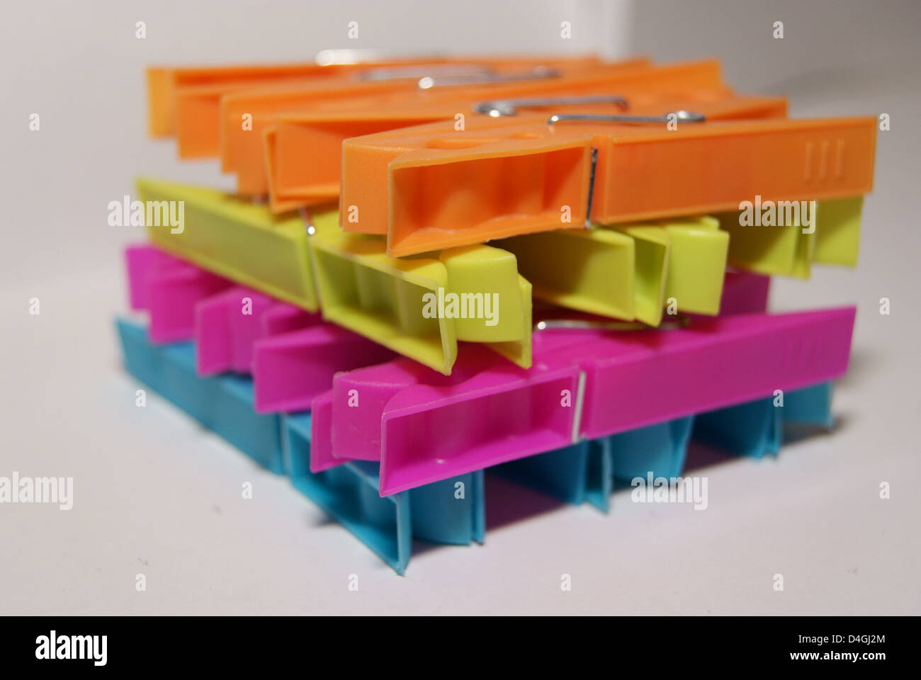 clothes pegs 4 colers stack Stock Photo - Alamy