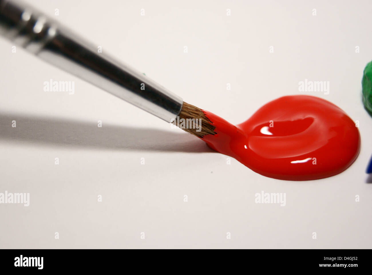 paintbrush in red paint Stock Photo - Alamy