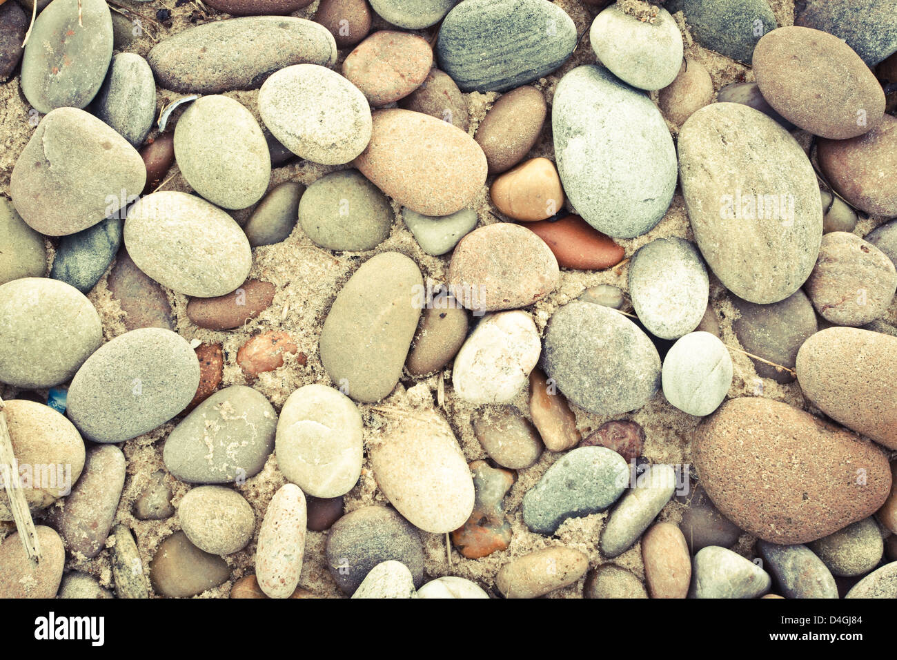 Pebbles and sand as a detailed background image Stock Photo - Alamy
