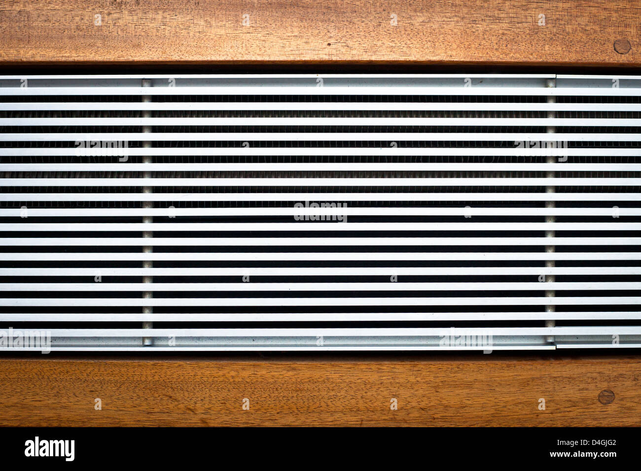 Metal heating unit in a wooden floor Stock Photo - Alamy
