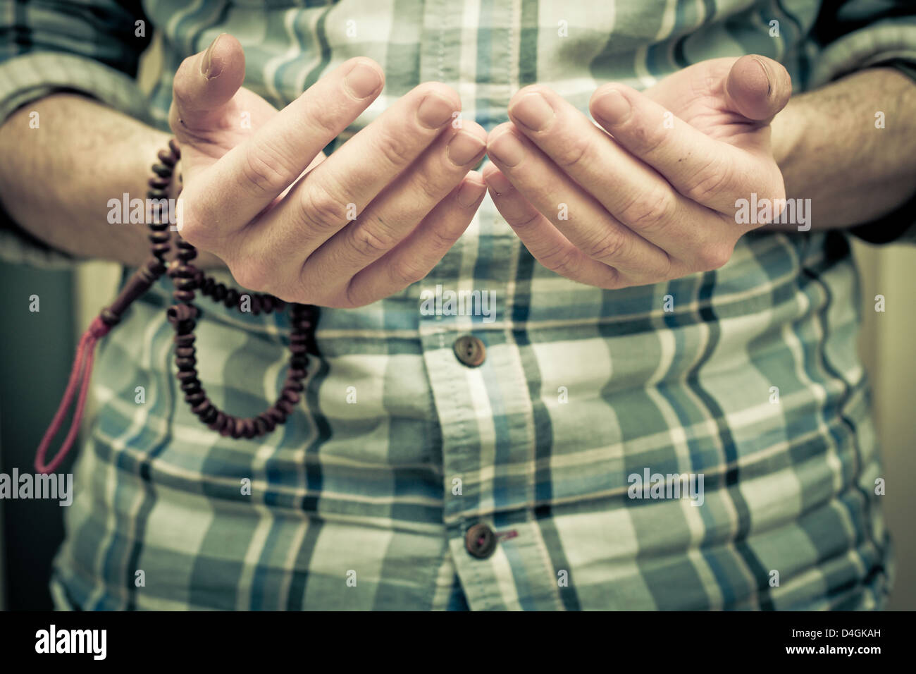 Hands of a young muslim man praying Stock Photo - Alamy