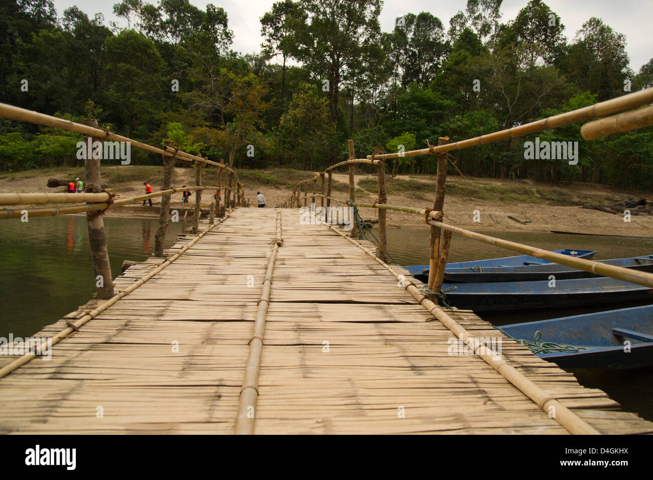 A bamboo footbridge stretches across a river Stock Photo - Alamy
