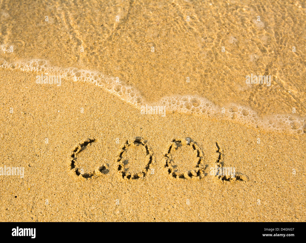 Cool - written in sand on beach texture - soft wave of the sea Stock ...