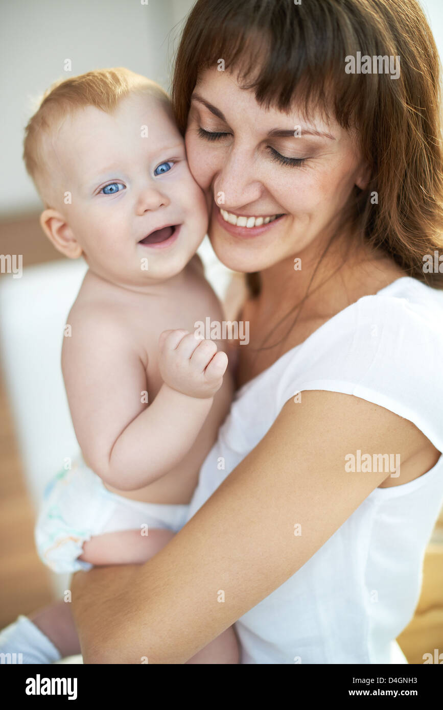 Portrait of happy woman expressing affection to her small son while ...