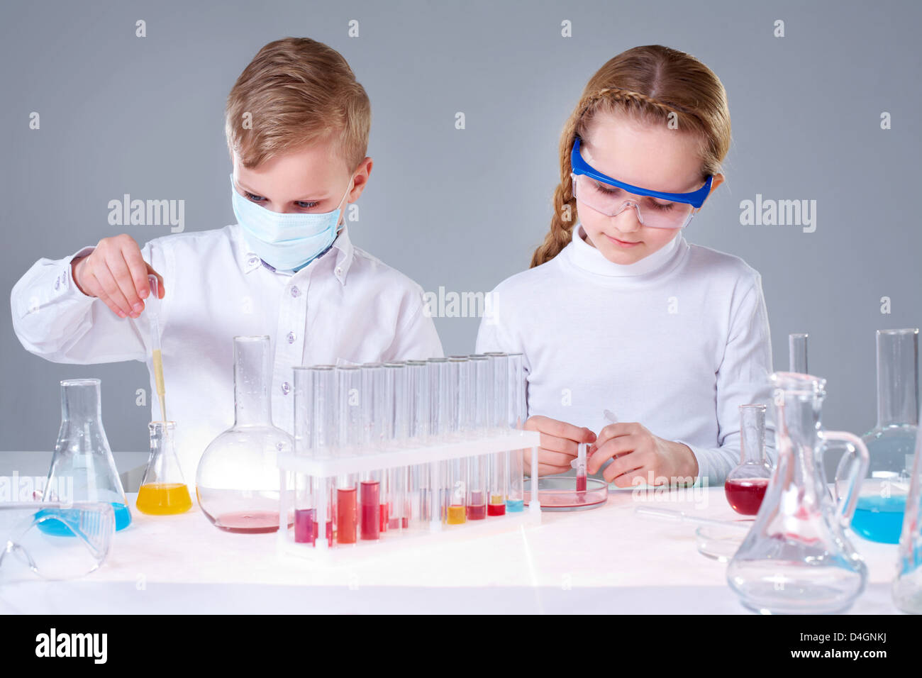 Two children making chemical experimentsin laboratory Stock Photo - Alamy