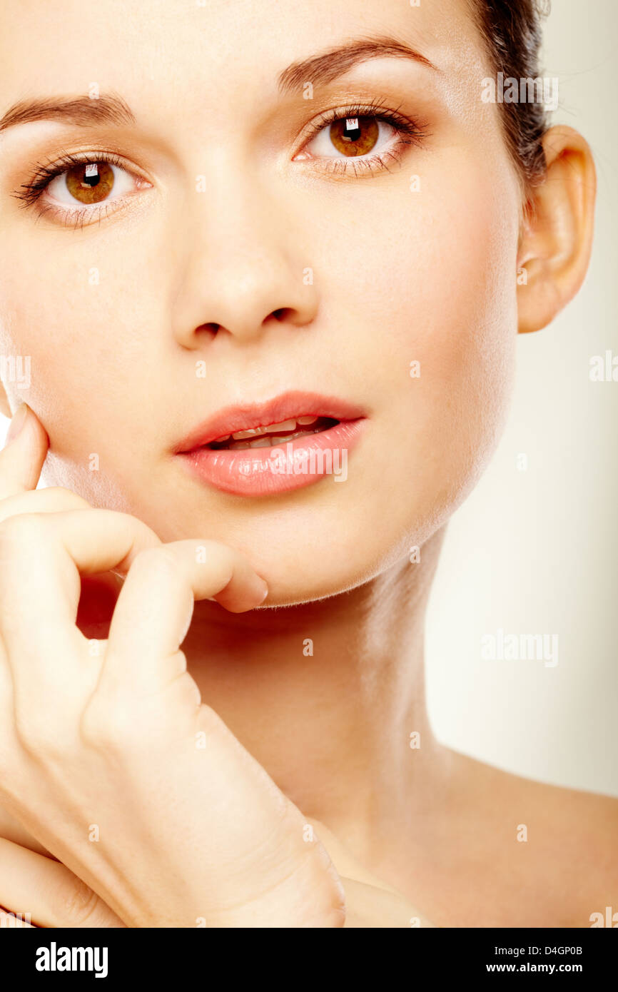 Gorgeous woman looking at camera over white background Stock Photo - Alamy