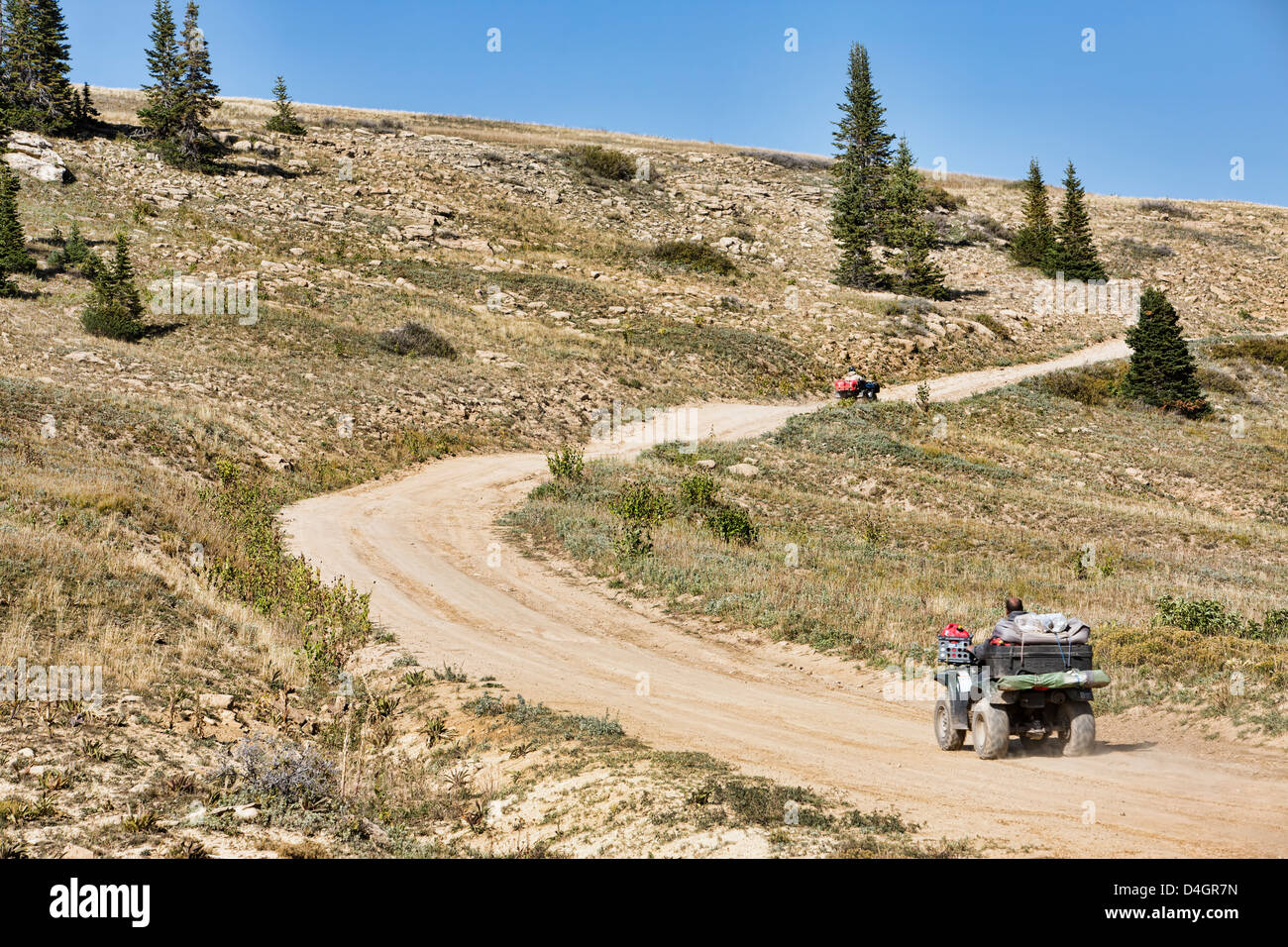 Sport vehicles climbing up a mountain. Fun outdoor recreation. Riding ...