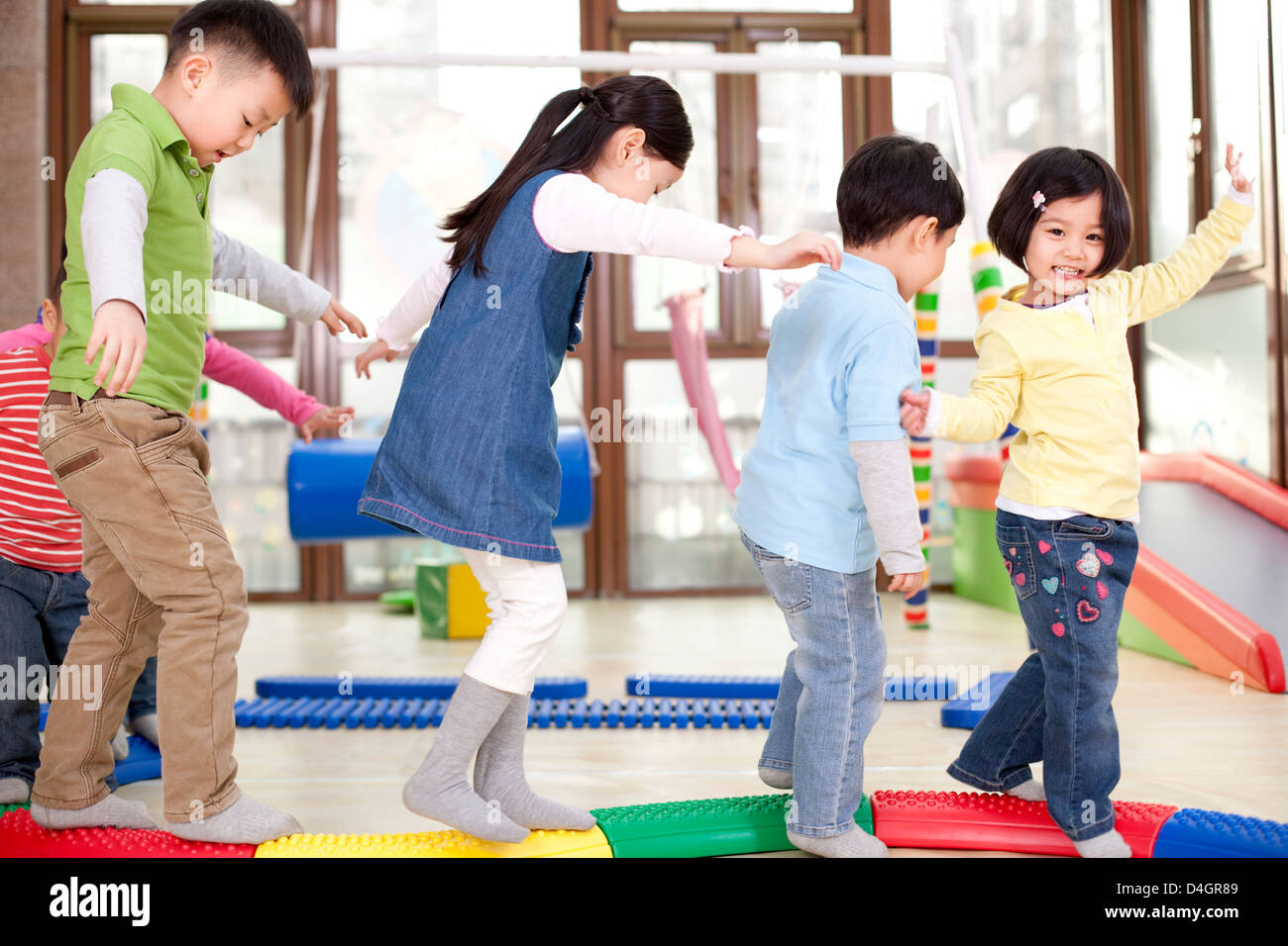 Happy kindergarten children playing games Stock Photo - Alamy