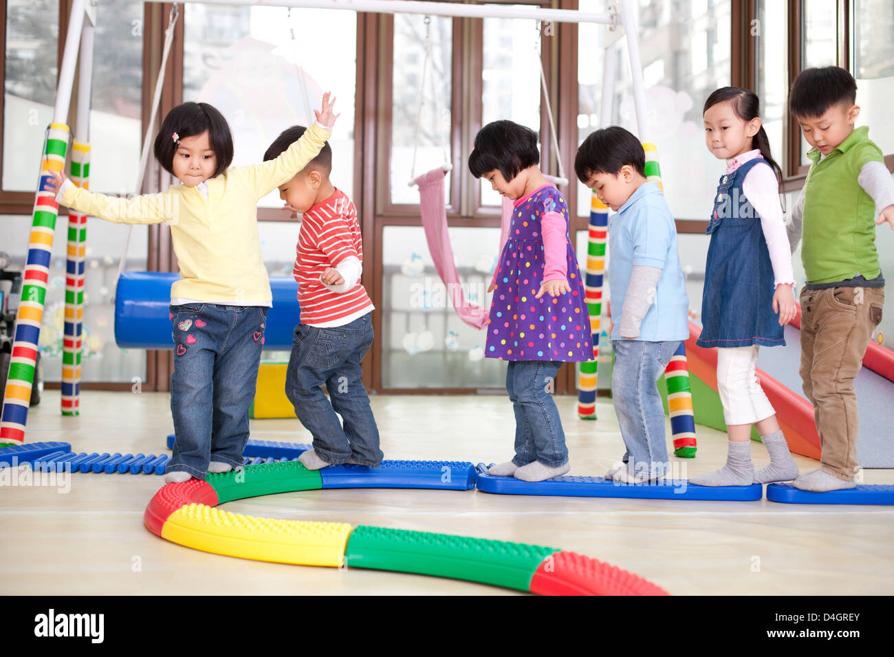 Happy kindergarten children playing games Stock Photo - Alamy