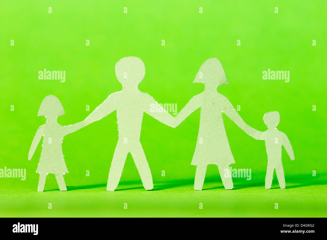 Family cutout shape isolated against a green background Stock Photo - Alamy