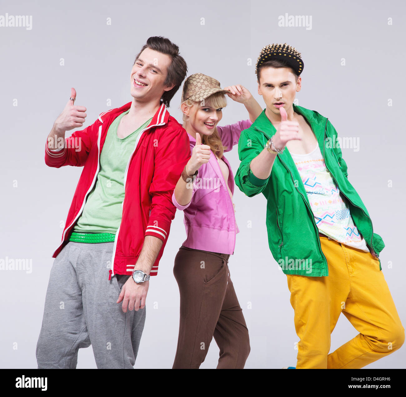 Three young friends in optimistic pose Stock Photo - Alamy