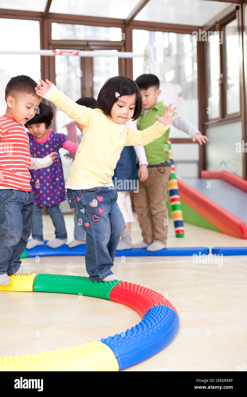 Happy kindergarten children playing games Stock Photo - Alamy