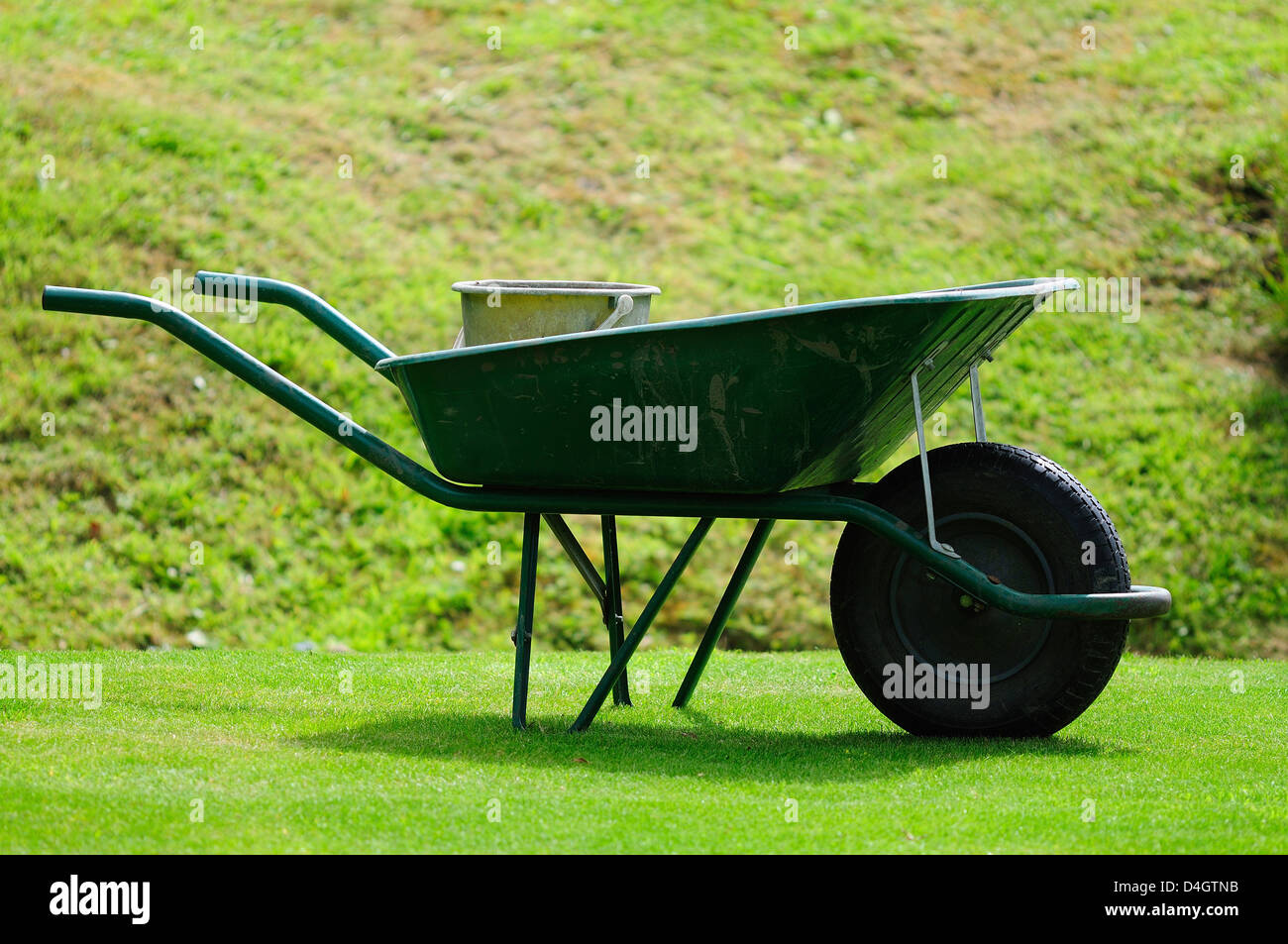 A garden wheelbarrow on a lawn Stock Photo - Alamy