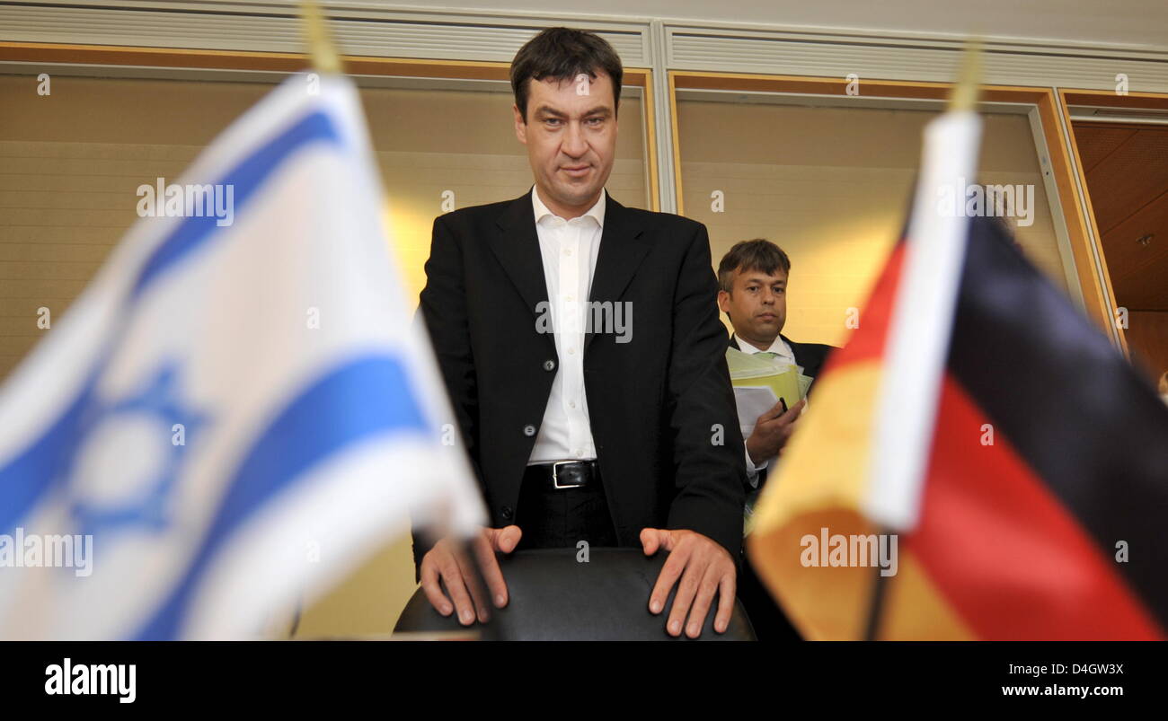 Markus Soeder seen between the Israeli and German flag in Tel Aviv ...