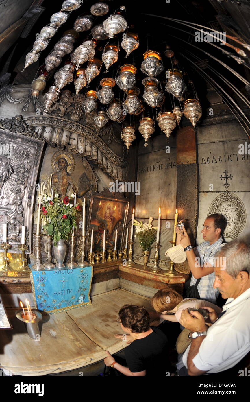 Visitors take pictures in the burial chamber of Jesus Christ at the ...