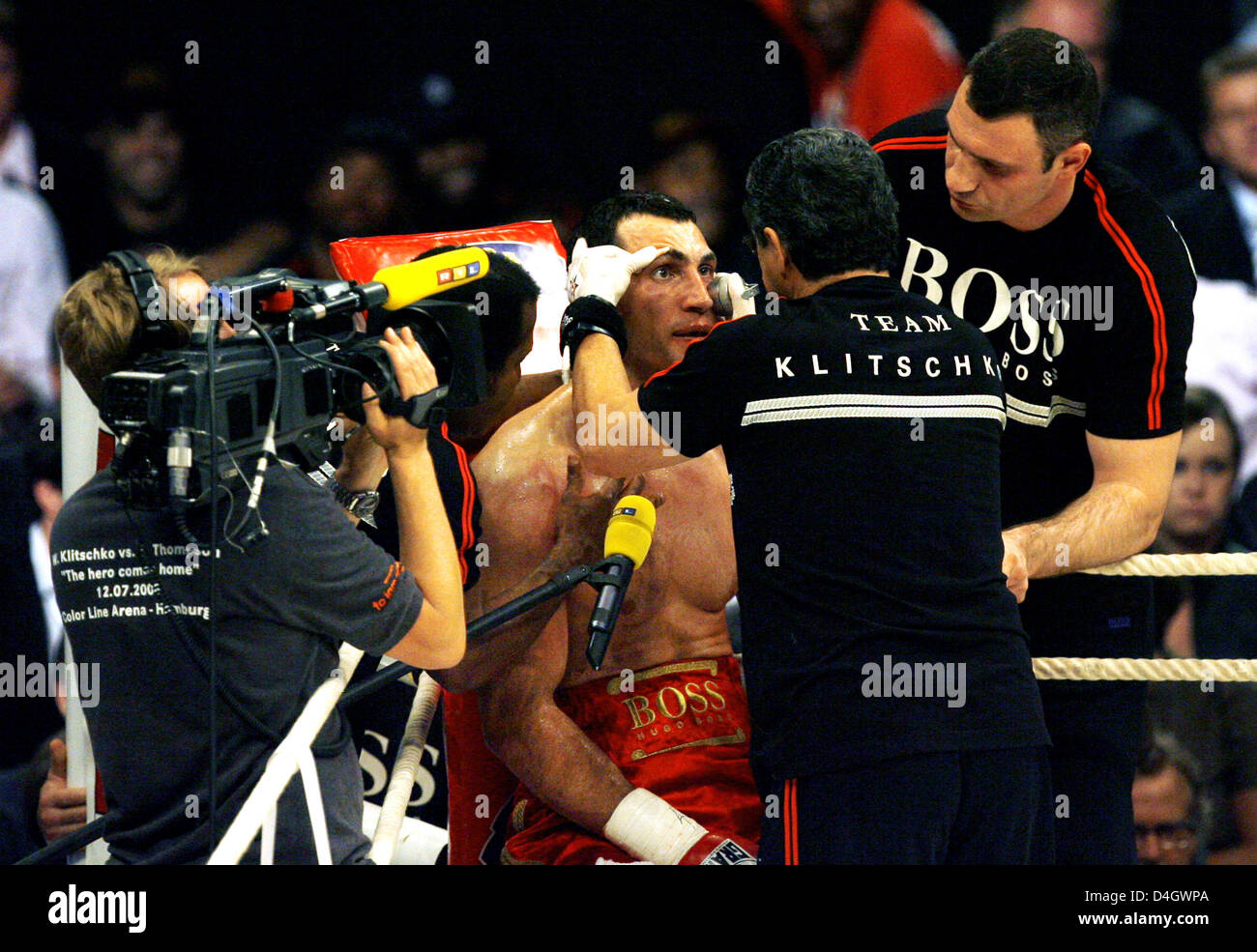 Ukrainian heavyweight boxer Vladimir Klitschko (2-L) is treated during ...