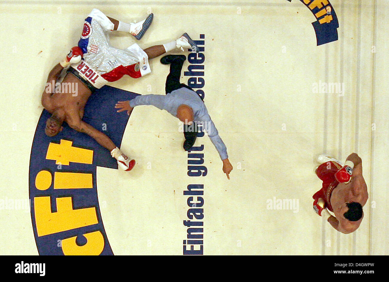 US boxer Tony Thompson (L) lies on the ground at the boxing ring of the ...