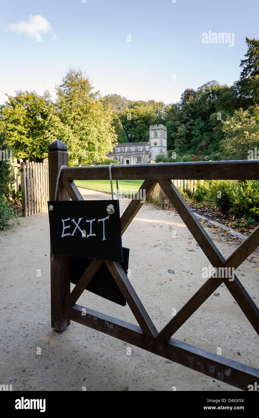 Exit sign on gate with church in background Stock Photo - Alamy