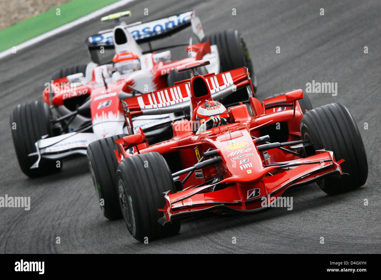 Finnish Formula One driver Kimi Raikkonen of Ferrari (R) is followed by ...