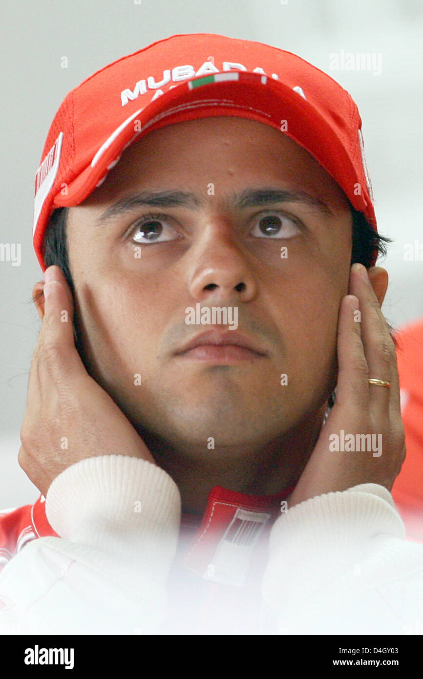 Brazilian Formula One driver Felipe Massa of Ferrari adjusts his ...