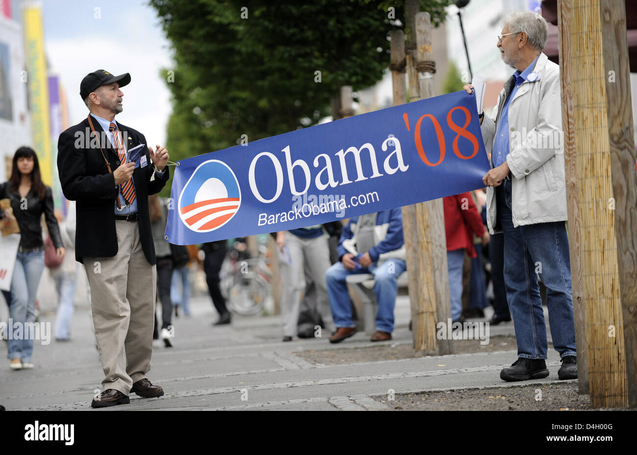 Party supporters of the American Democrats hold up a banner informing ...