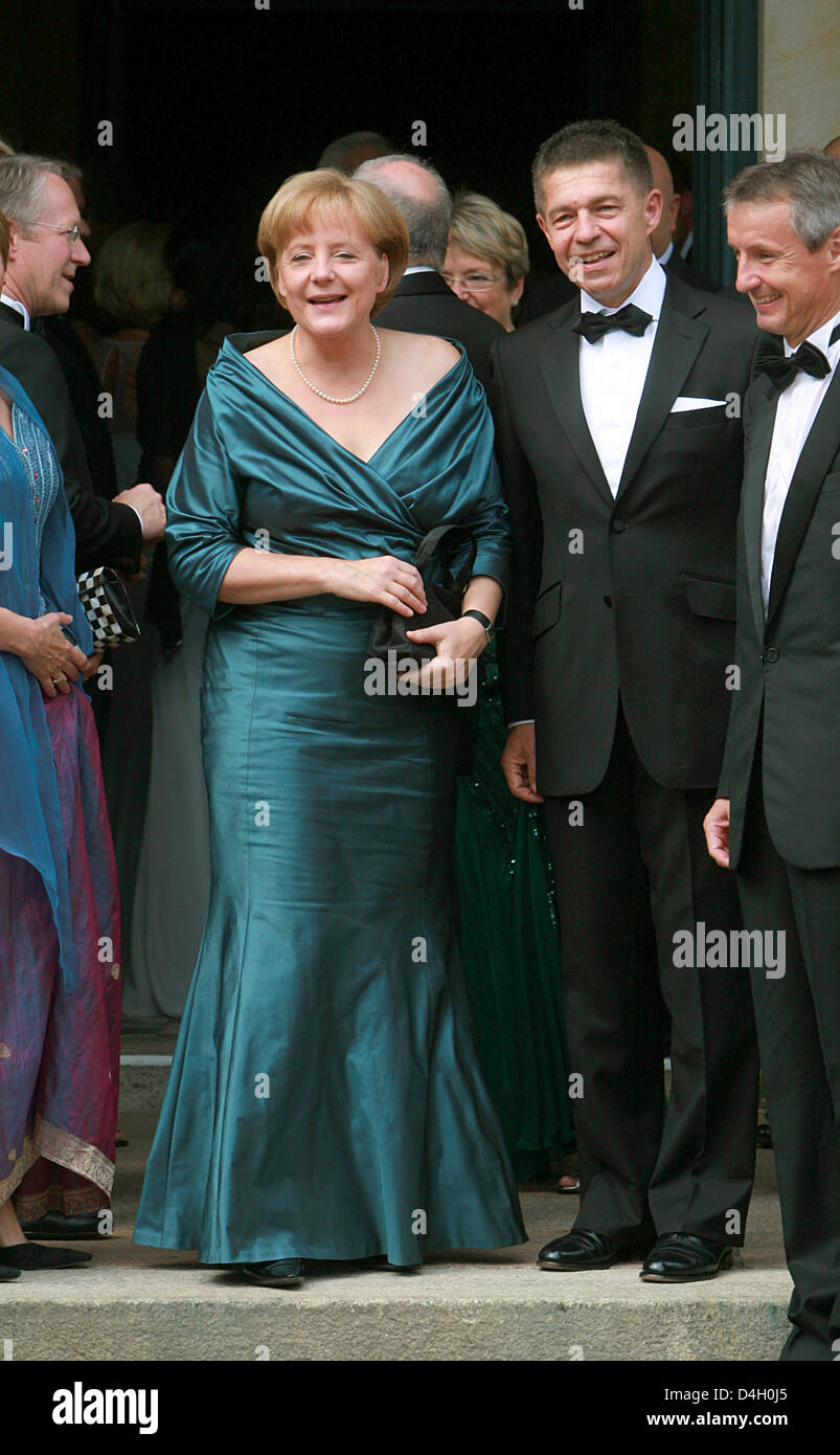 German Chancellor Angela Merkel and her husband Joachim Sauer arrive at ...