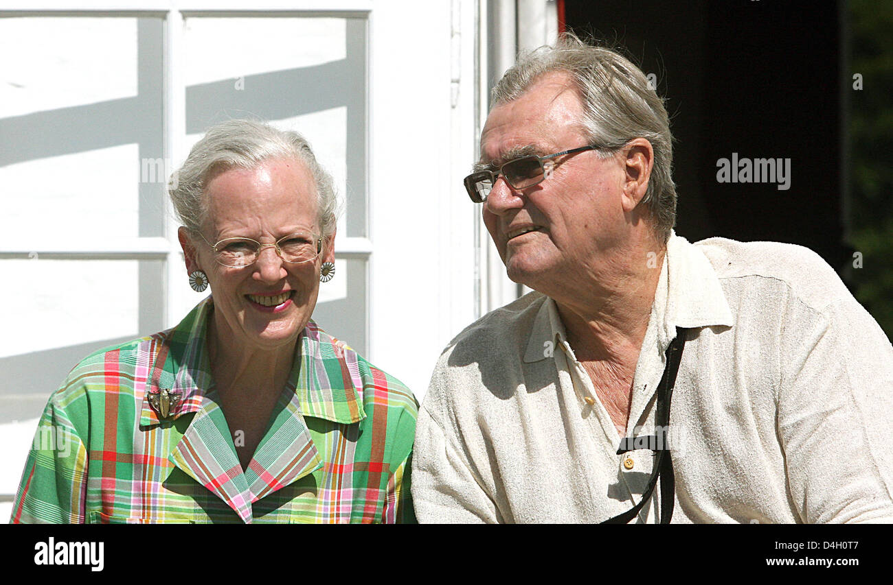Danish Queen Margrethe and Prince Consort Henrik sit in the sun ouside ...