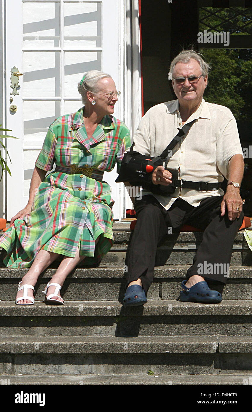 Danish Queen Margrethe and Prince Consort Henrik sit in the sun ouside ...