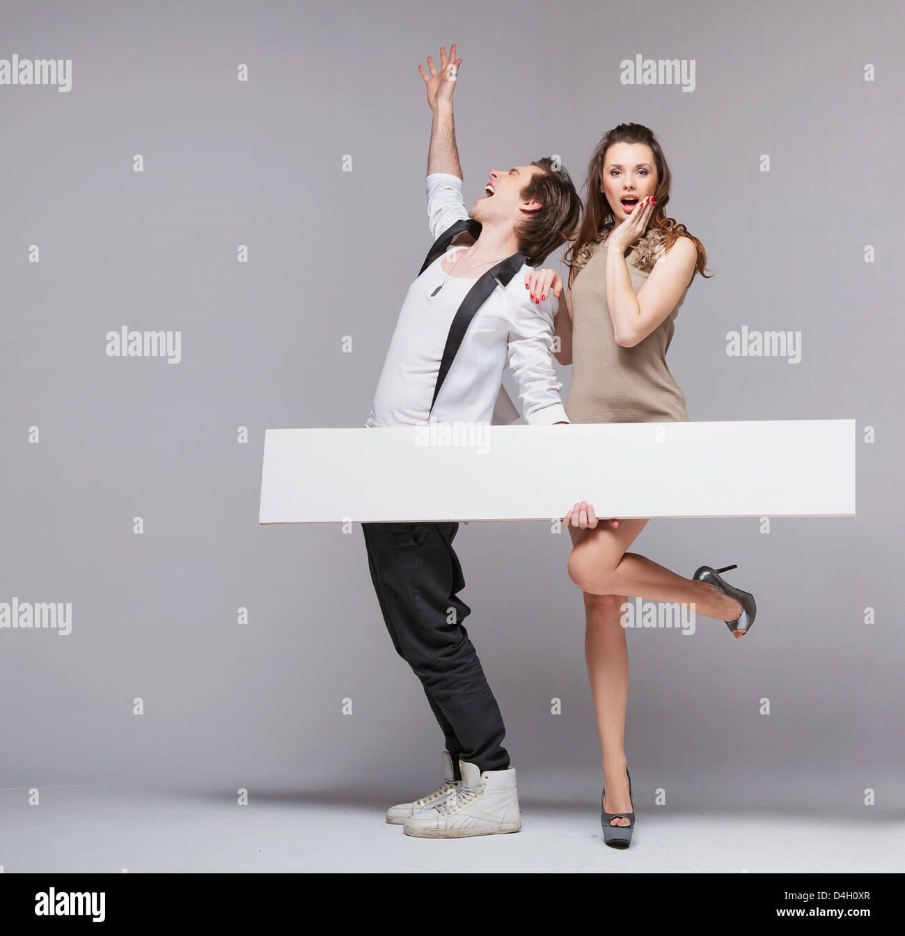 Screaming guy in funny pose with his pretty girlfriend Stock Photo - Alamy