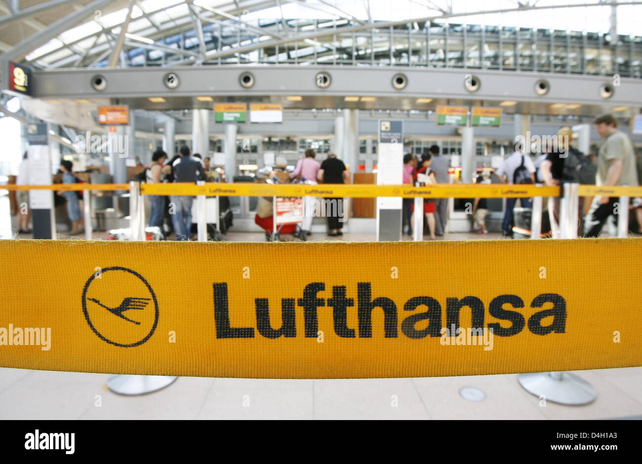 Travellers check in at Lufthansa counters in Hamburg, Germany, 29 July ...