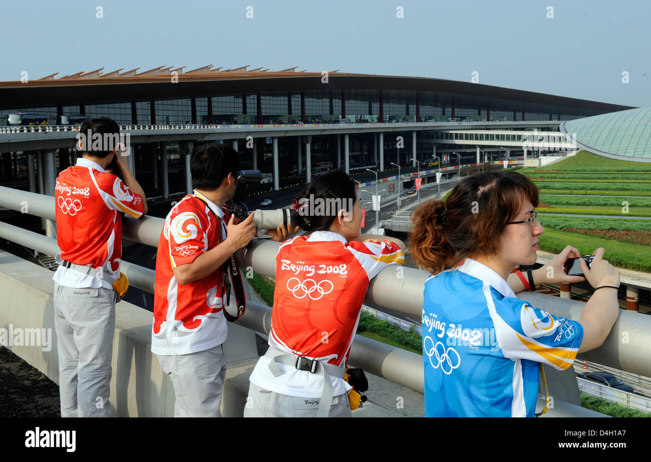 Olympic service staff seen at the new airport terminal in Beijing ...