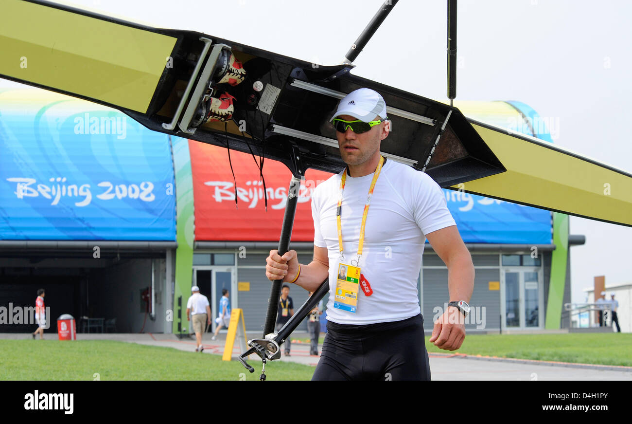 German rower Marcel Hacker brings his boat to the waters in Beijing ...