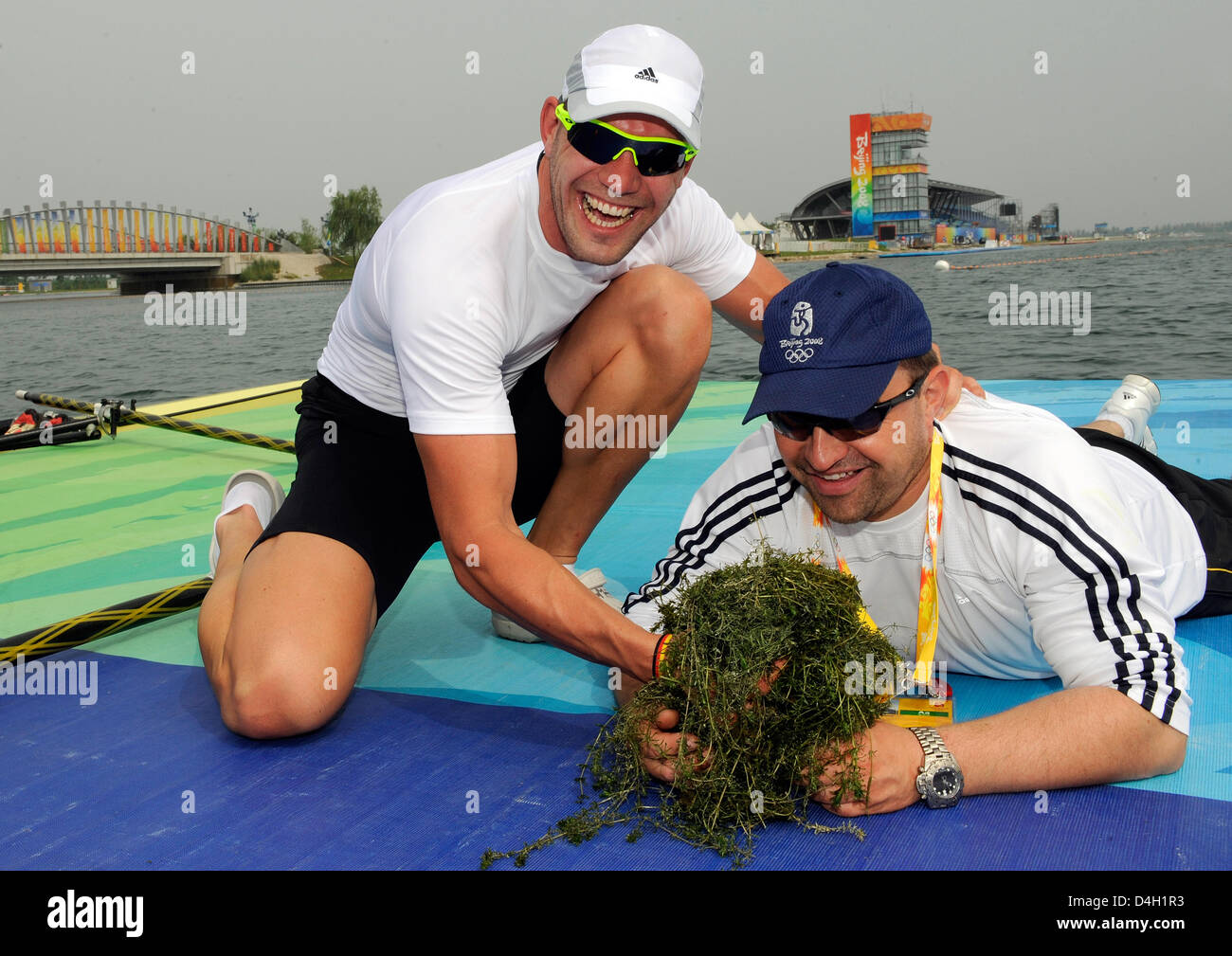German rower Marcel Hacker (L) and his coach Anndreas Maul (R) joke at ...