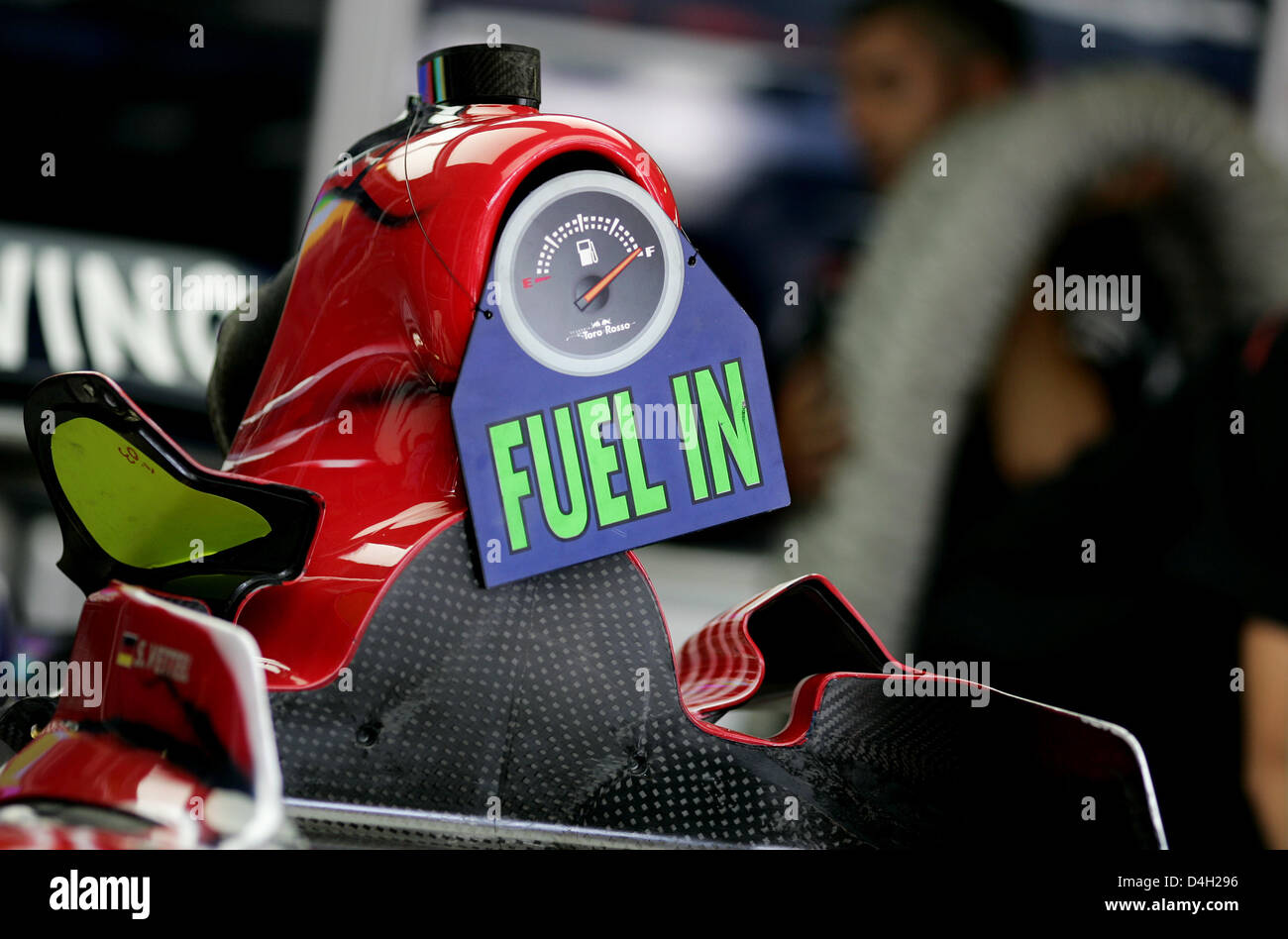 A sign reading 'fuel in' is mounted at the cockpit of a Toro Rosso race ...