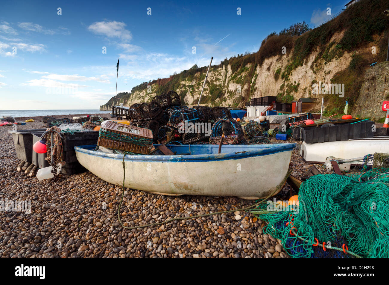 A fishing boat with nets and lobster pots on the beach at Beer on the ...