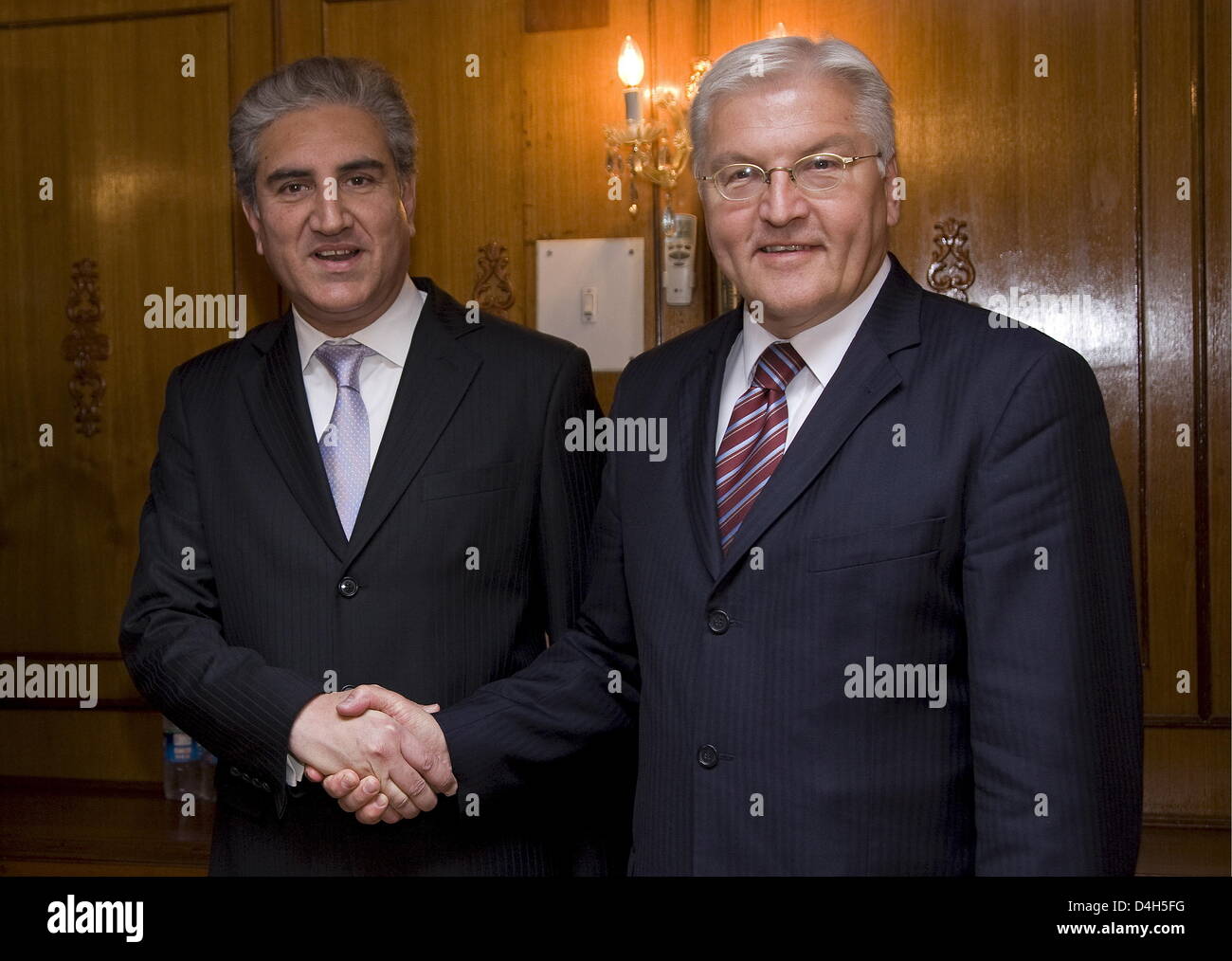 German Foreign Minister Frank-Walter Steinmeier (R) shakes hands with ...
