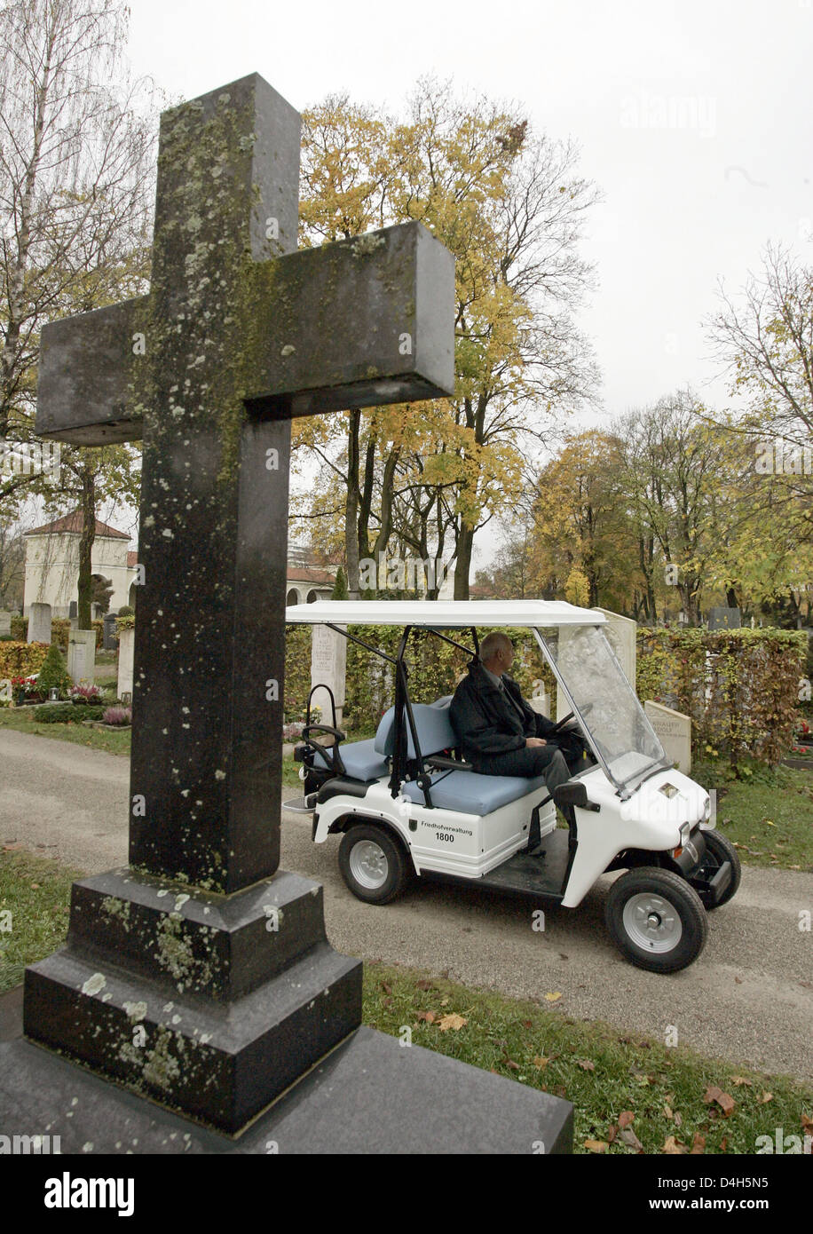 An employee drives the cemetery vehicle at the northern cemetery in ...
