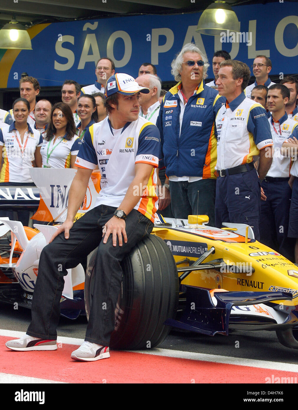 Spanish Formula One driver Fernando Alonso (C) of Renault sits on the ...