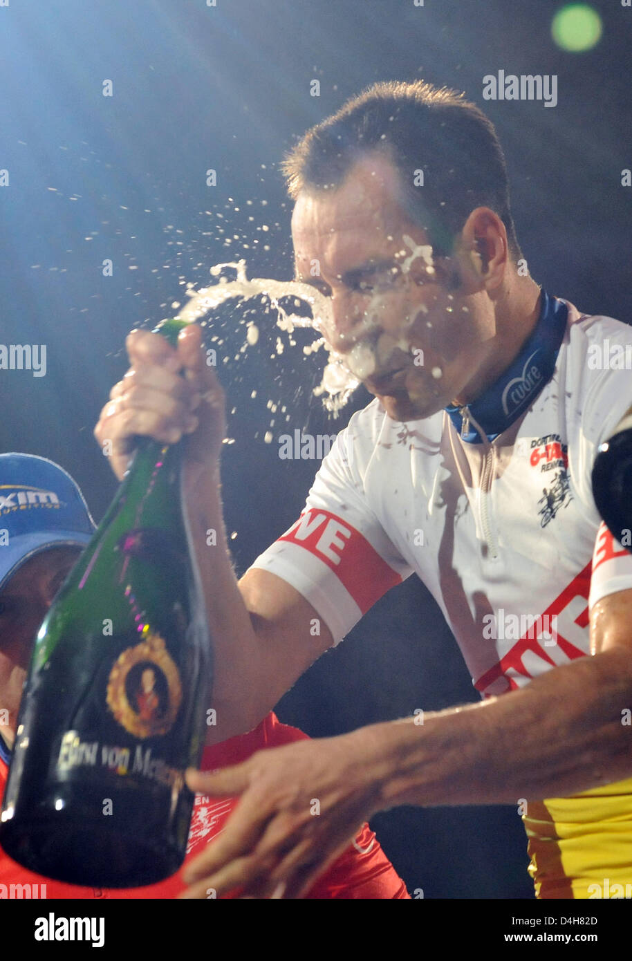 German professional cyclist Erik Zabel opens a bottle of champagne ...