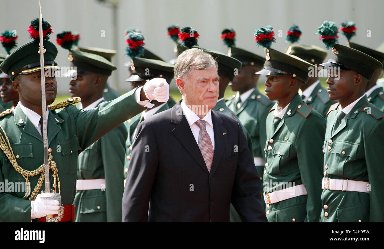 German President Horst Koehler (C) is officially received with military ...