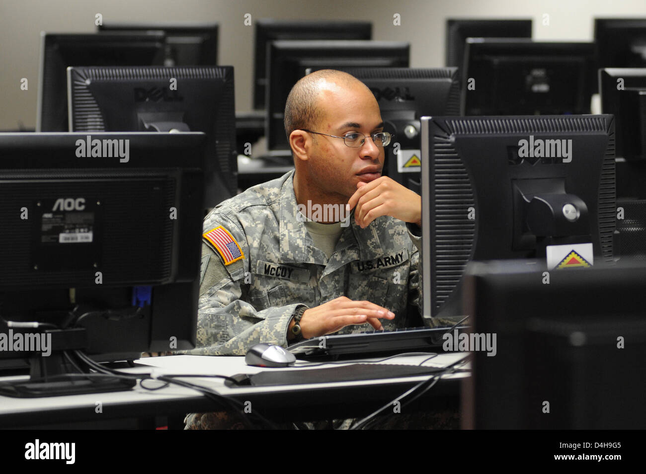 A U.S. soldier practices a combat operation on a computer at training ...
