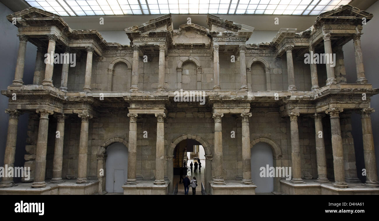 Visitors to the Pergamon museum eye the Market Gate of Miletus in ...