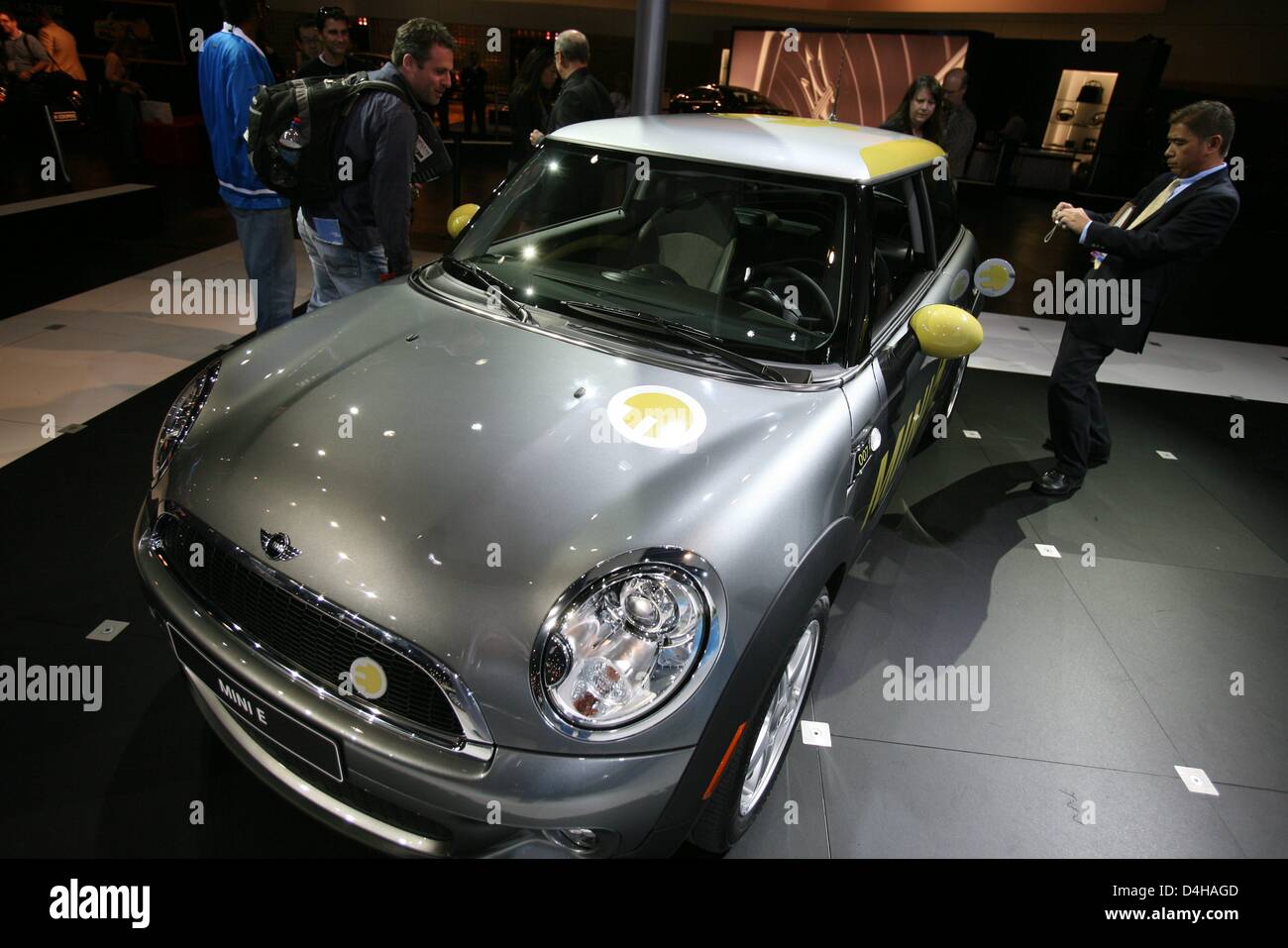 Visitors examine the new electric drive Mini at the Mini booth of the ...
