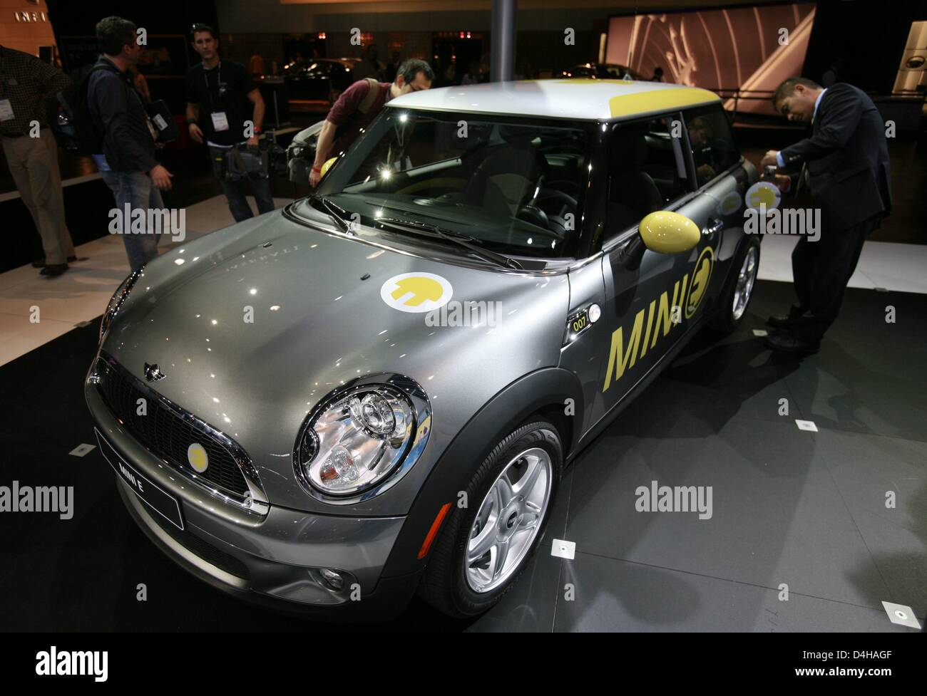 Visitors examine the new electric drive Mini at the Mini booth of the ...