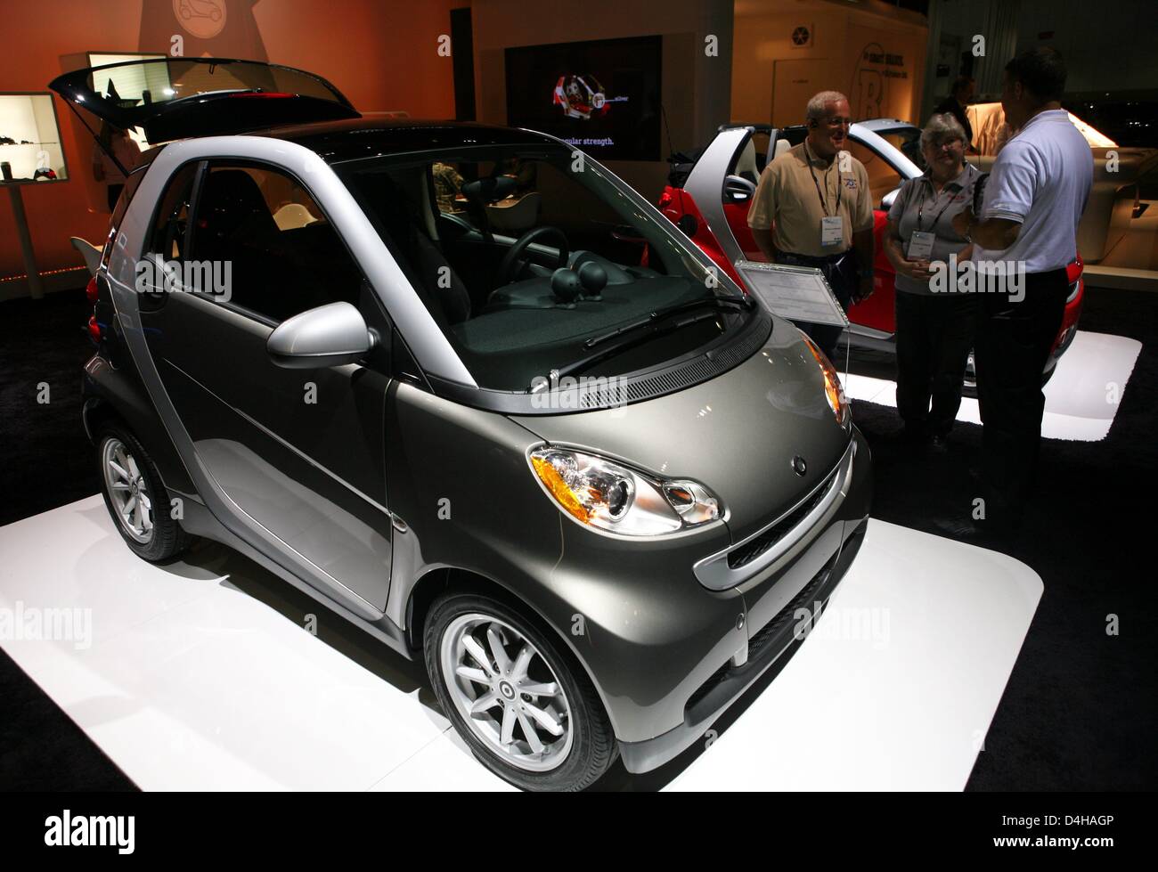 Visitors are pictured at the Smart booth during the Los Angeles Auto ...