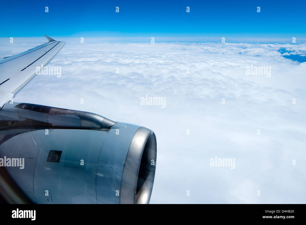 view from an airplane flying in the clouds. wing floating above the ...