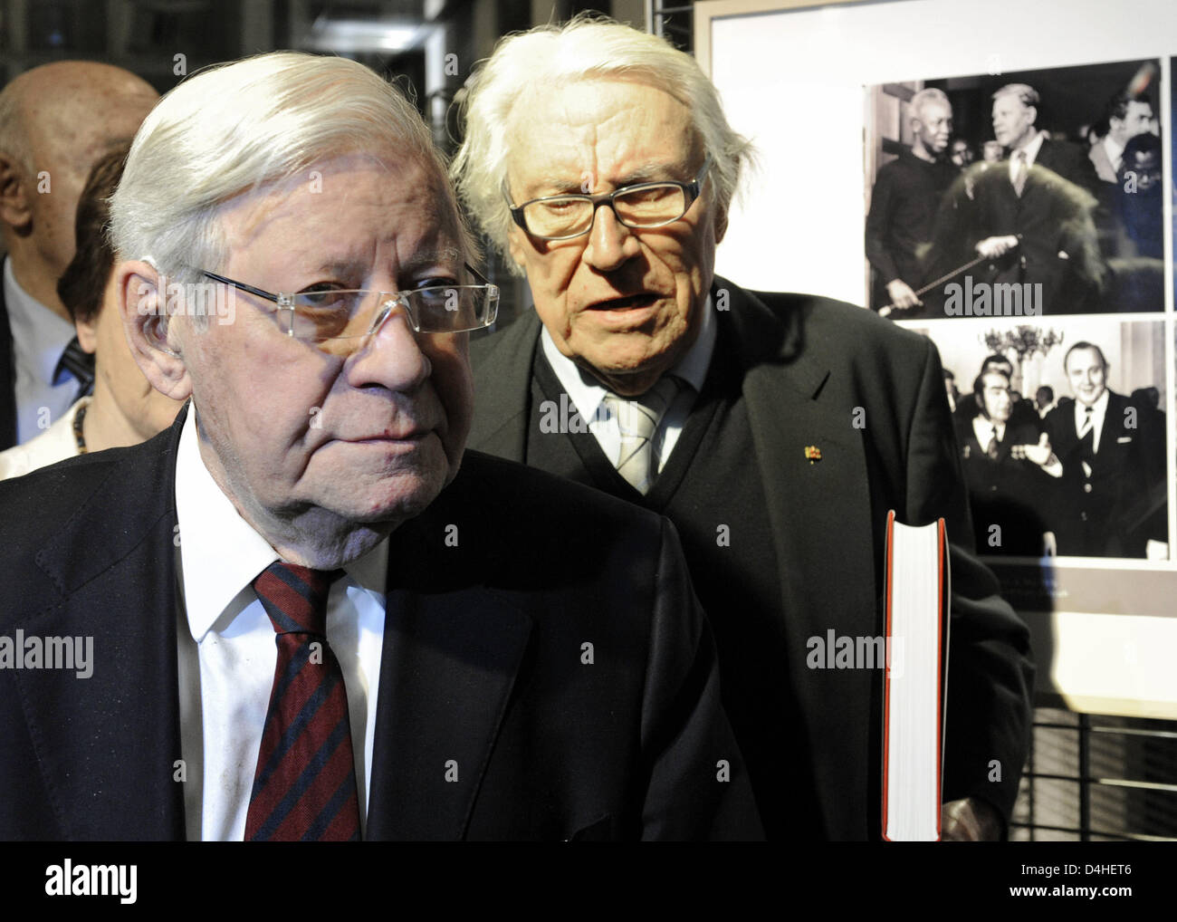 Former German Chancellor Helmut Schmidt looks at a photo exhibition, which portrays his ...
