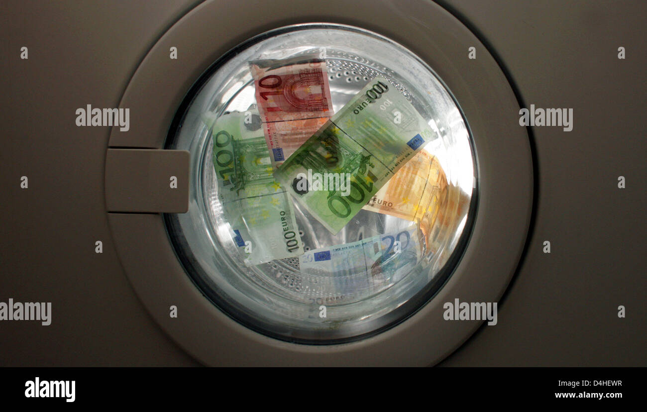 The symbolic photo shows euro notes inside a washing machine, depicted ...