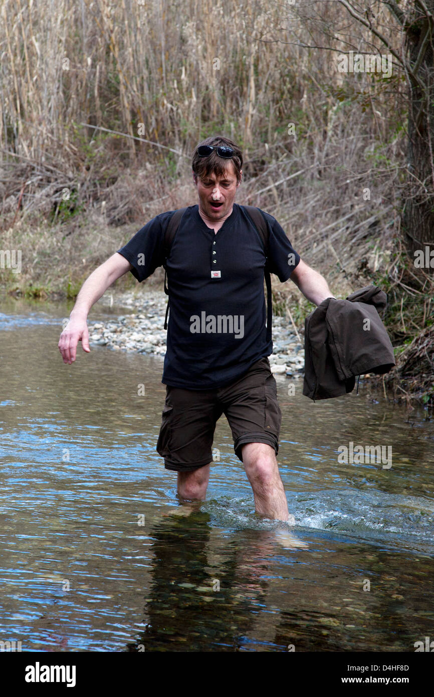 Man walking across shallow river nr.Falset, Priorat Stock Photo - Alamy